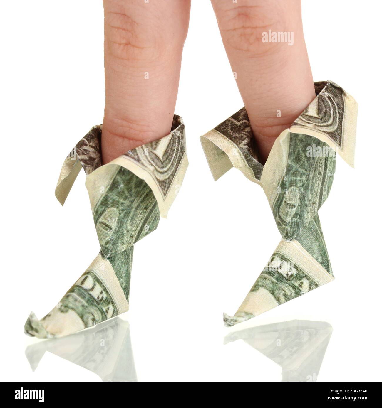Dollars folded into boots on fingers of woman's hand isolated on white ...