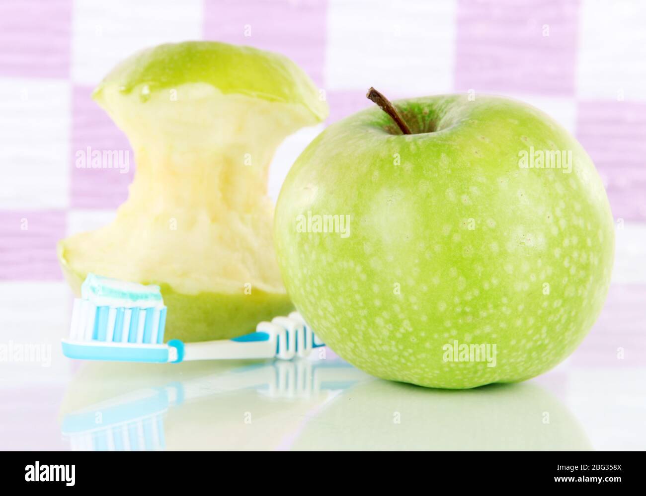 Apples with a toothbrush on shelf in bathroom Stock Photo - Alamy