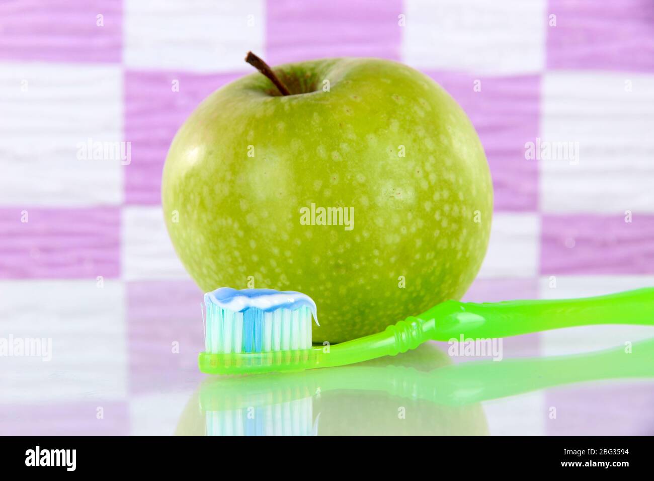 Apple with a toothbrush on shelf in bathroom Stock Photo - Alamy