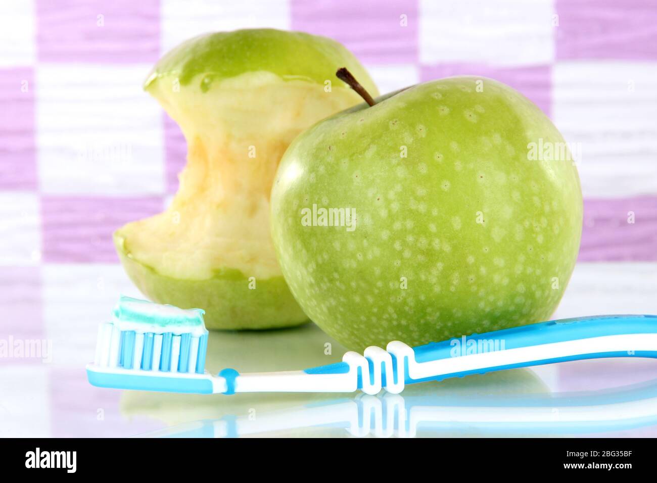 Apples with a toothbrush on shelf in bathroom Stock Photo - Alamy