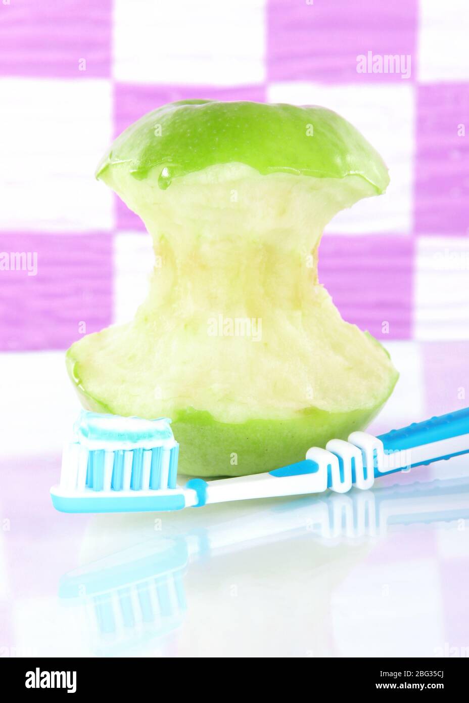 Apple with a toothbrush on shelf in bathroom Stock Photo - Alamy
