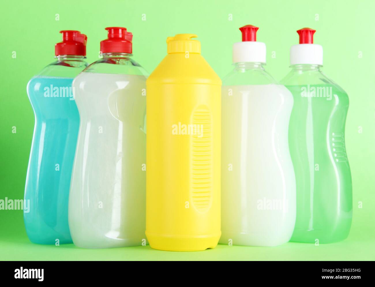 Bottles of dishwashing liquid on color background Stock Photo - Alamy