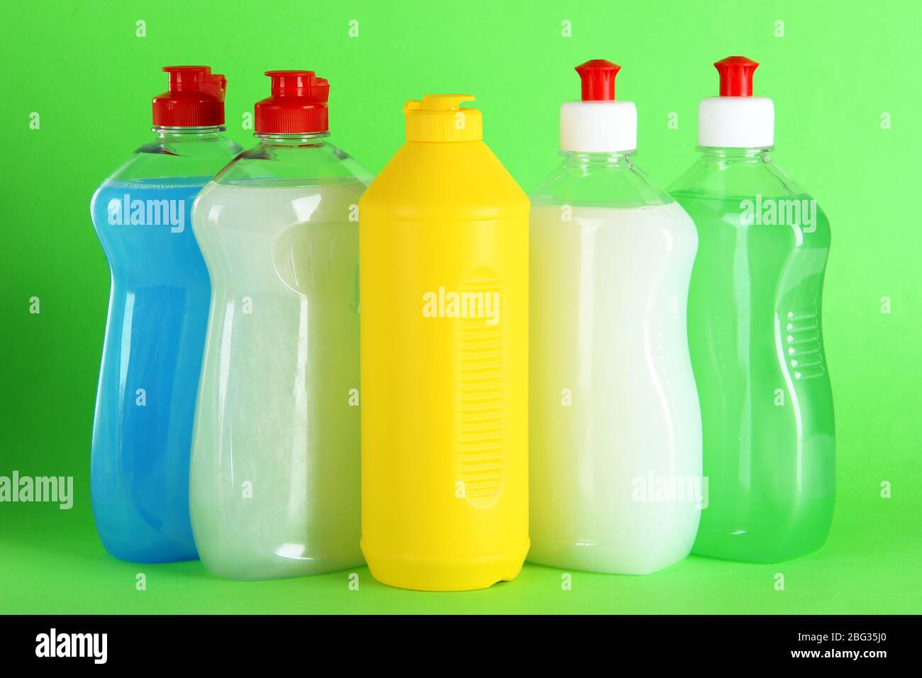 Bottles of dishwashing liquid on color background Stock Photo - Alamy