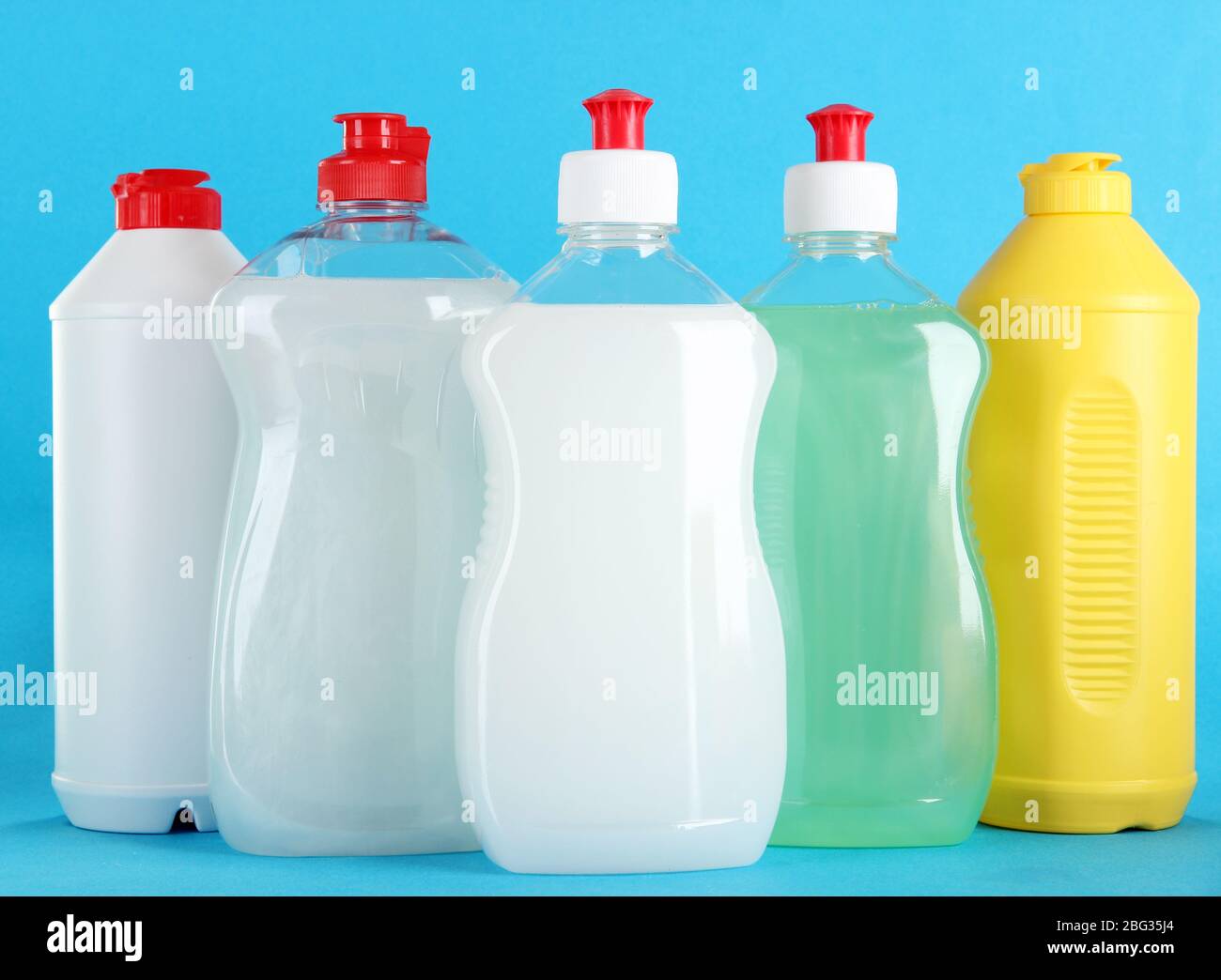 Bottles of dishwashing liquid on color background Stock Photo - Alamy