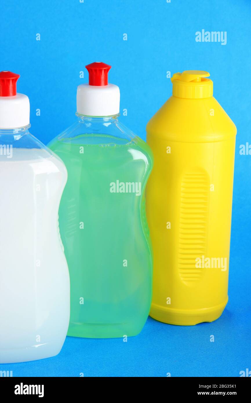 Bottles of dishwashing liquid on color background Stock Photo - Alamy