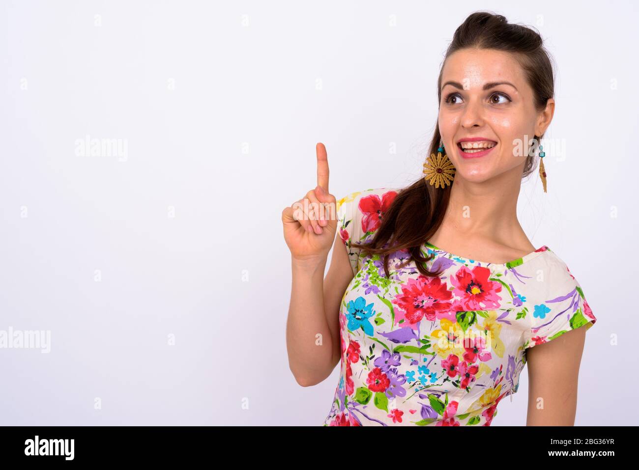 Portrait of happy young beautiful woman thinking and pointing up Stock ...
