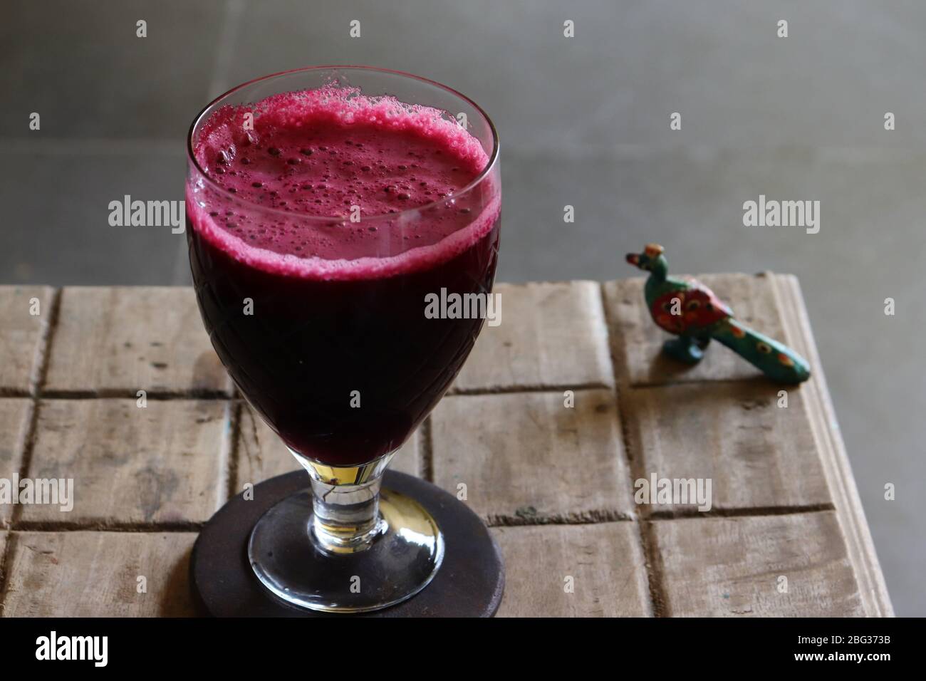 A glass of fresh homemade beetroot juice on a wooden table Stock Photo ...