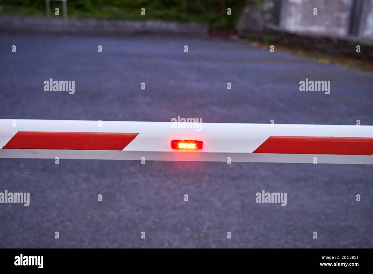 Warning red light on a car park barrier early evening Stock Photo - Alamy
