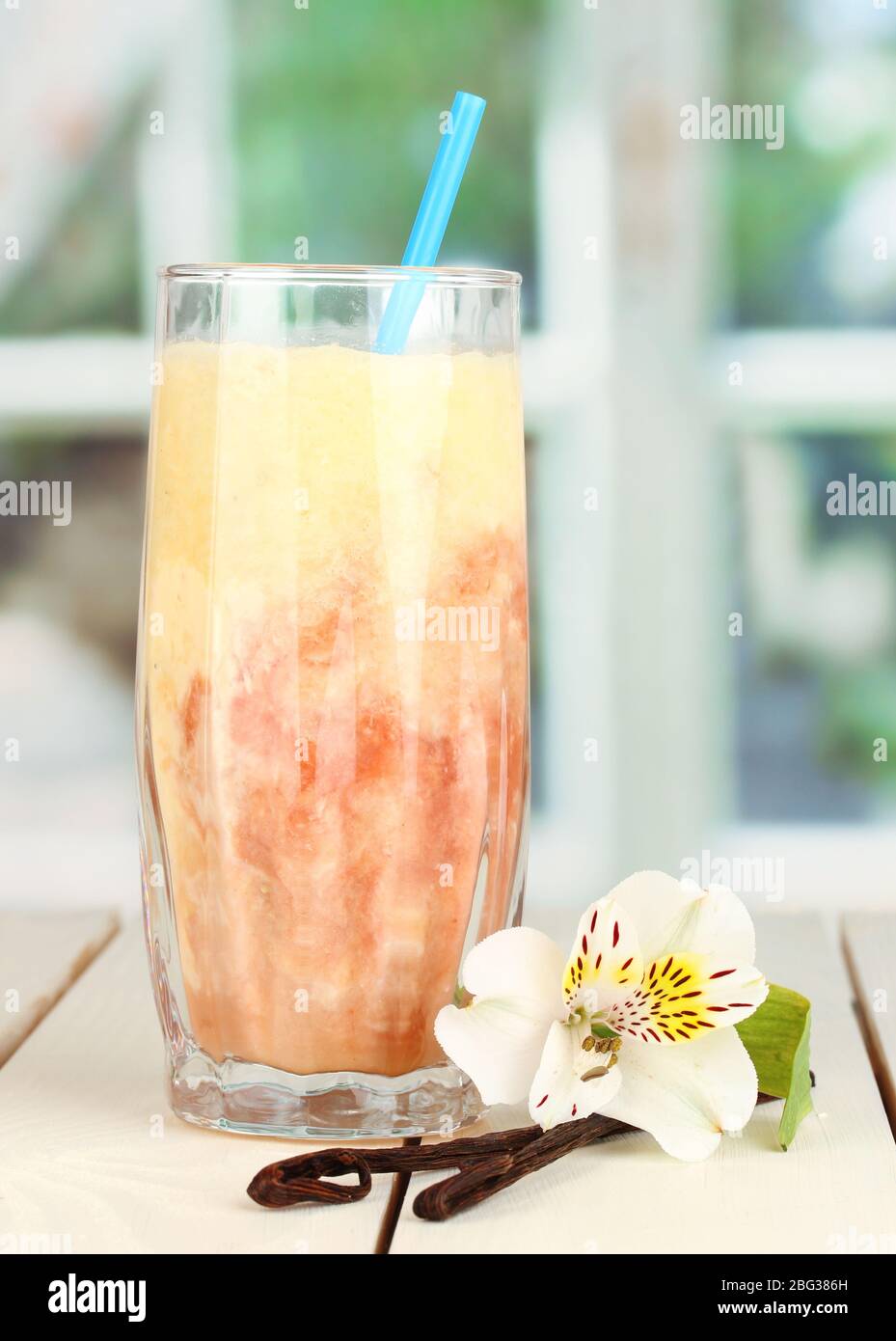 Delicious fruit smoothie on wooden table on window background Stock ...