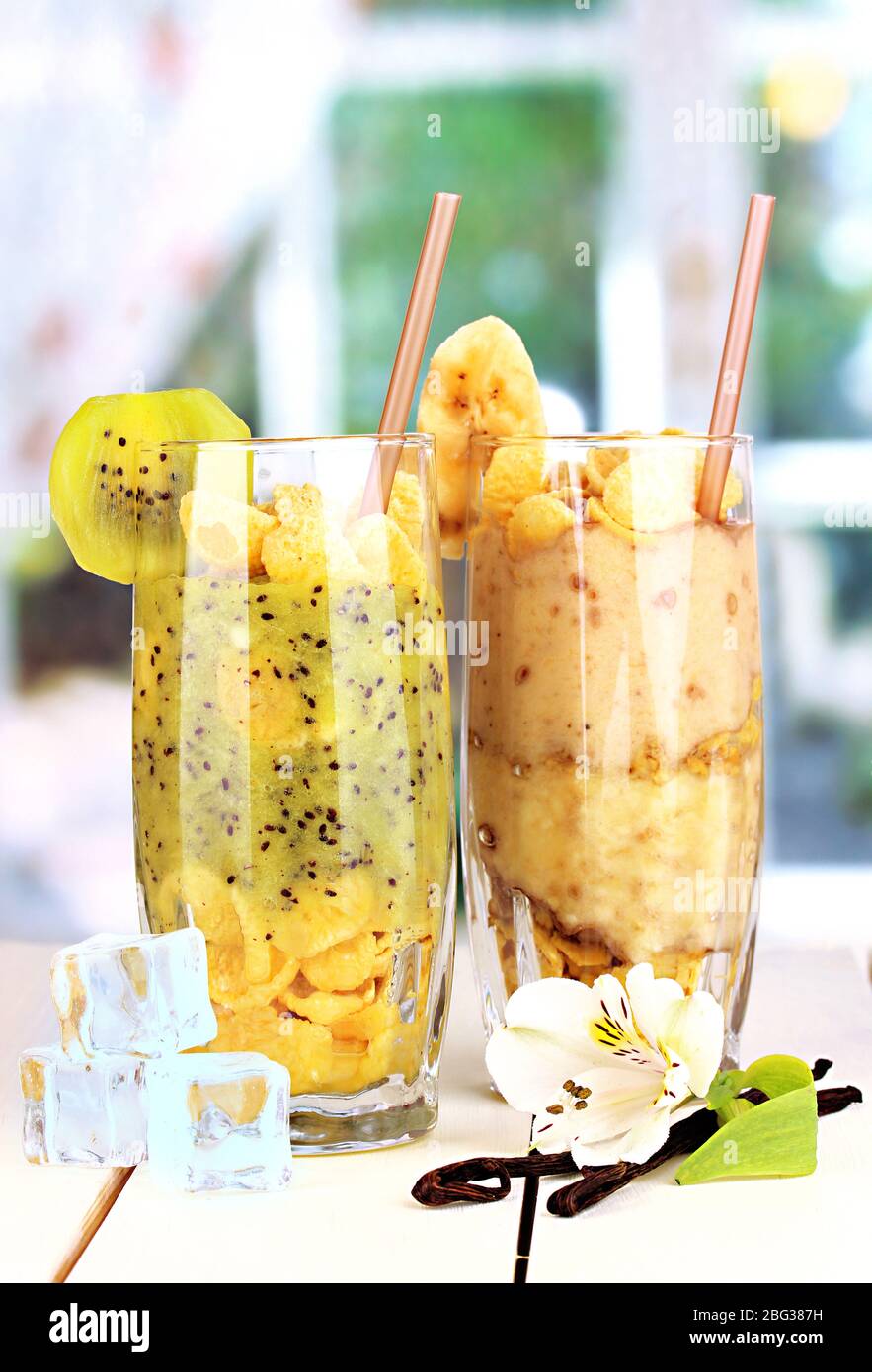Delicious fruit smoothies on wooden table on window background Stock ...