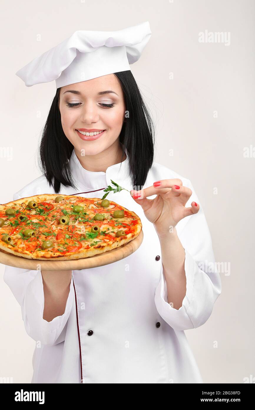 Beautiful girl chief-cooker with pizza isolated on white Stock Photo ...