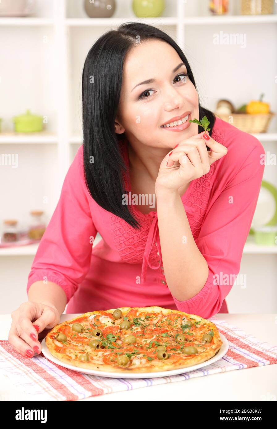 Beautiful girl with delicious pizza on kitchen background Stock Photo ...
