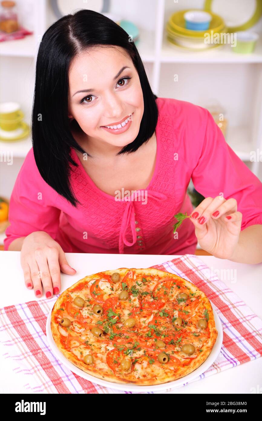 Beautiful girl with delicious pizza on kitchen background Stock Photo ...