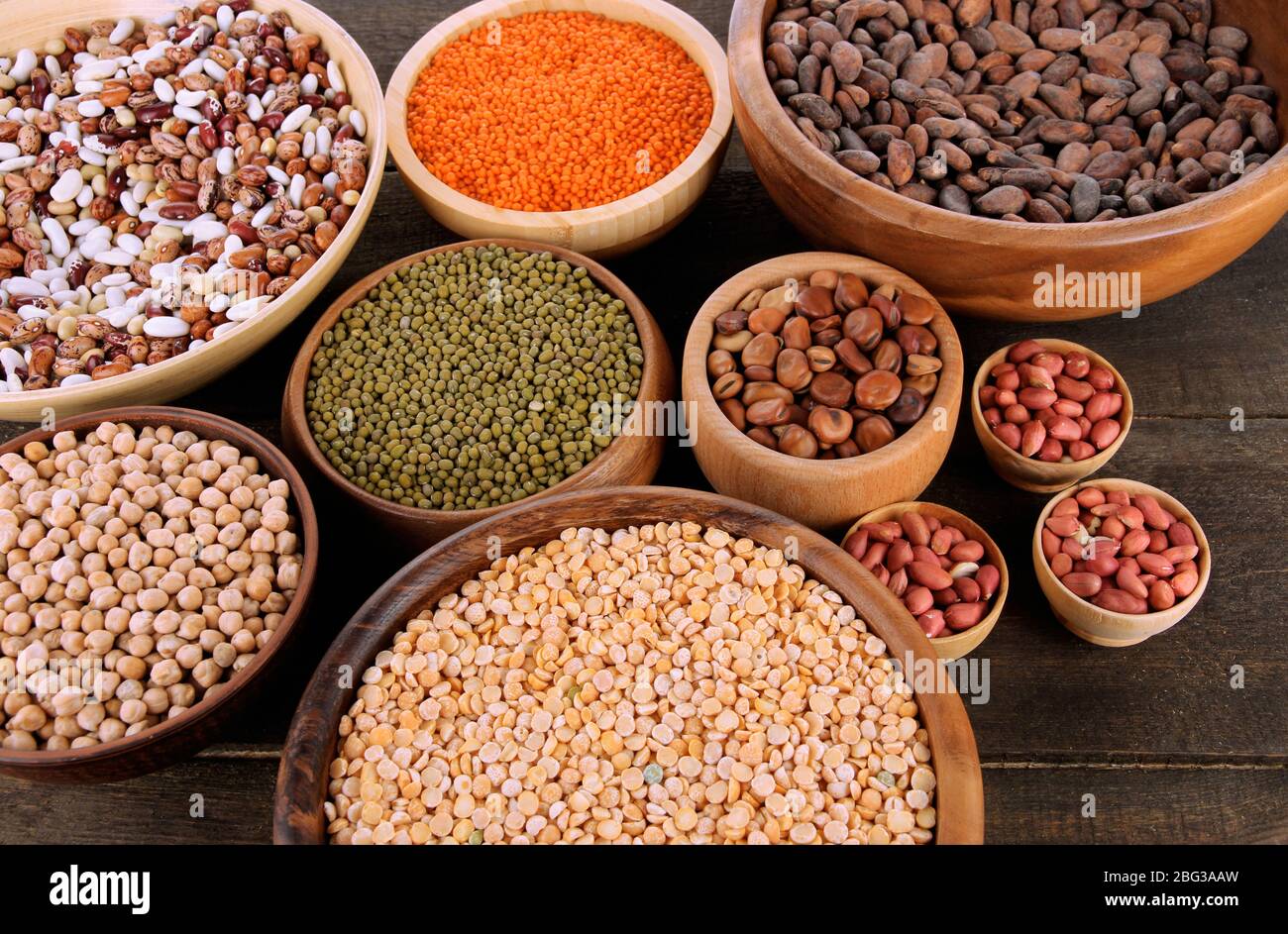 Different kinds of beans in bowls on table close-up Stock Photo - Alamy
