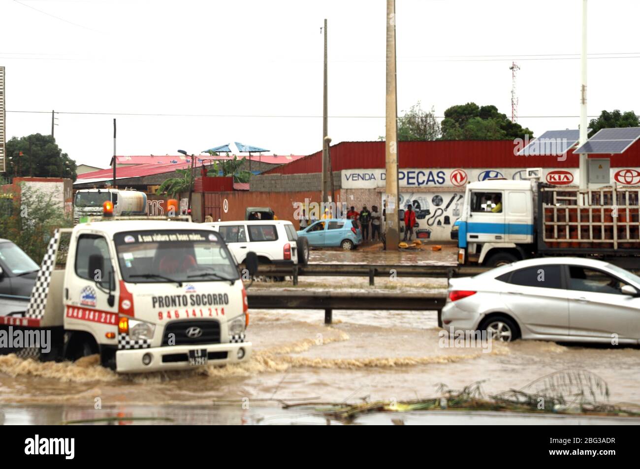 Luanda, Angola. 18th Apr, 2020. Vehicles drive on a flooded street ...