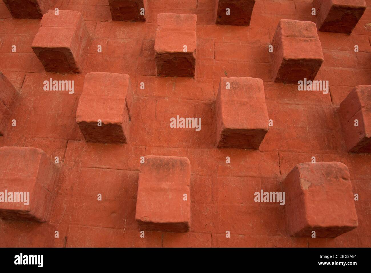 Abstract orange bricks with cubical structure popping out of the wall ...