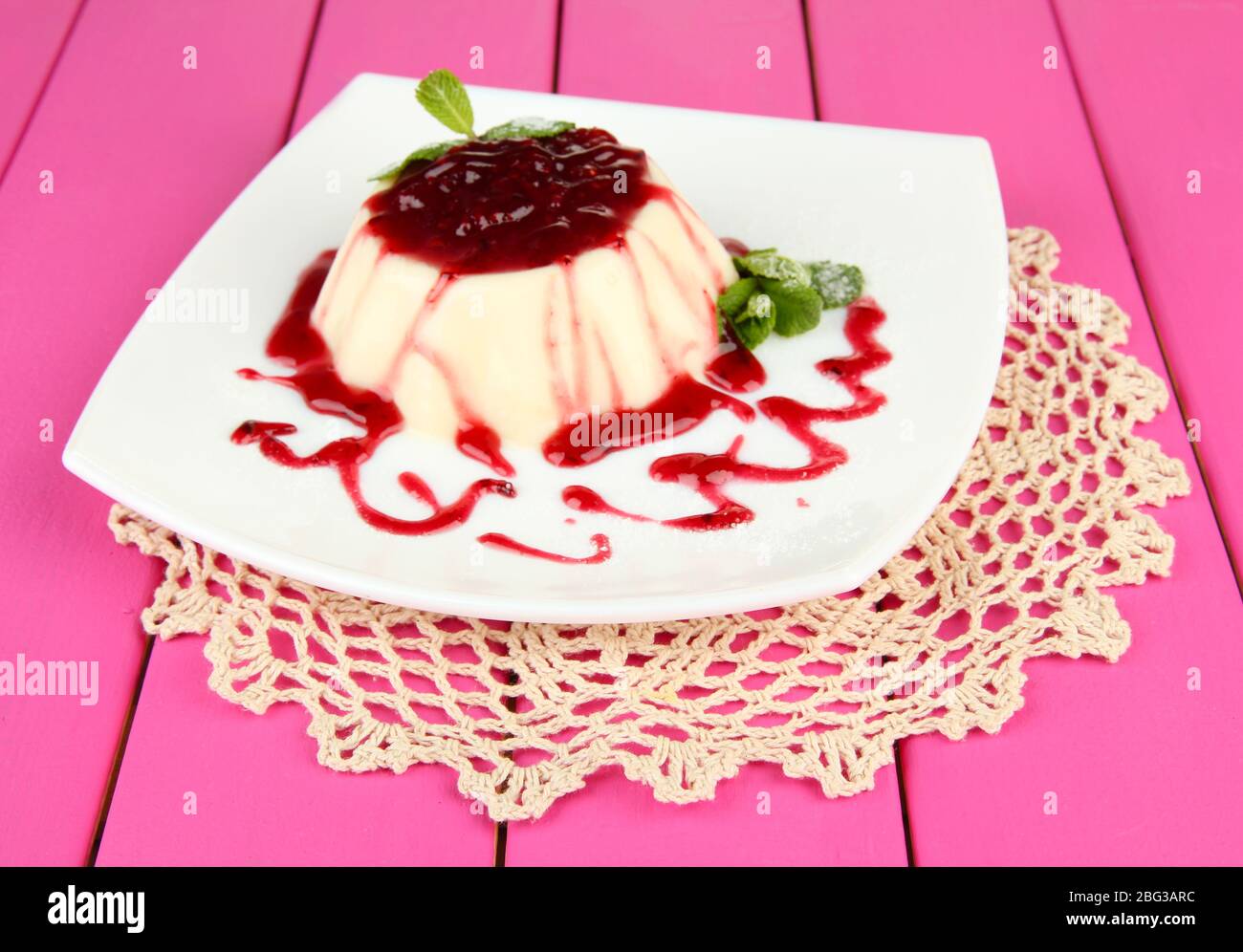 Panna Cotta with raspberry sauce, on color wooden background Stock ...