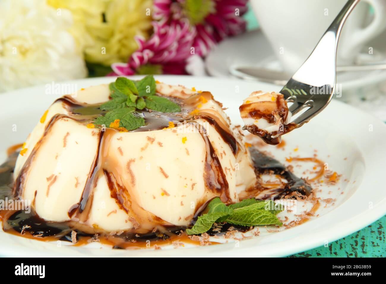 Panna Cotta with chocolate and caramel sauces, on color wooden ...