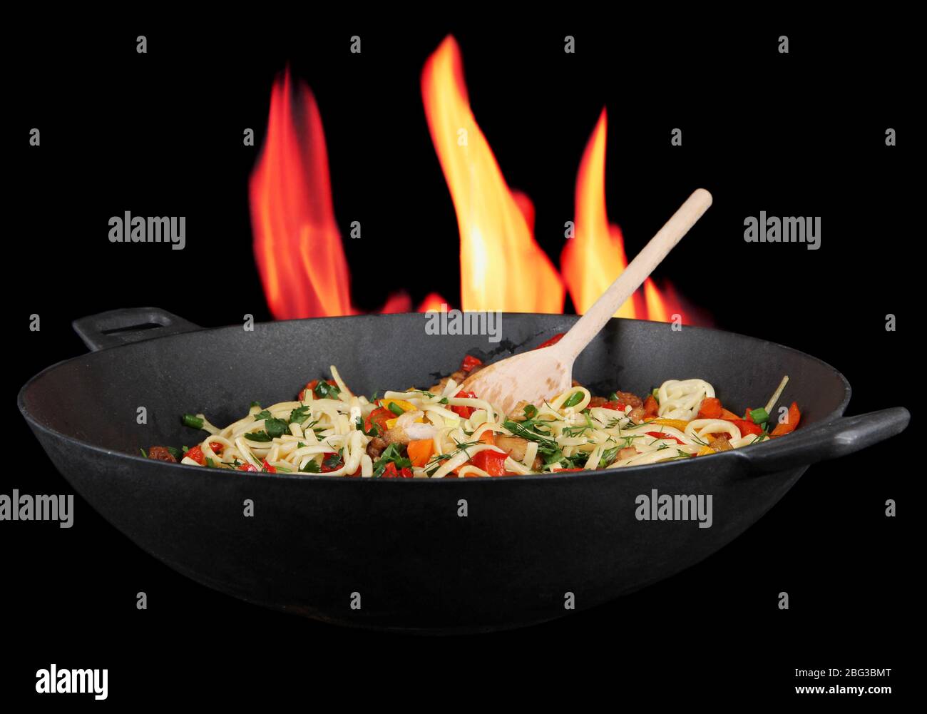Noodles with vegetables on wok on fire background Stock Photo - Alamy