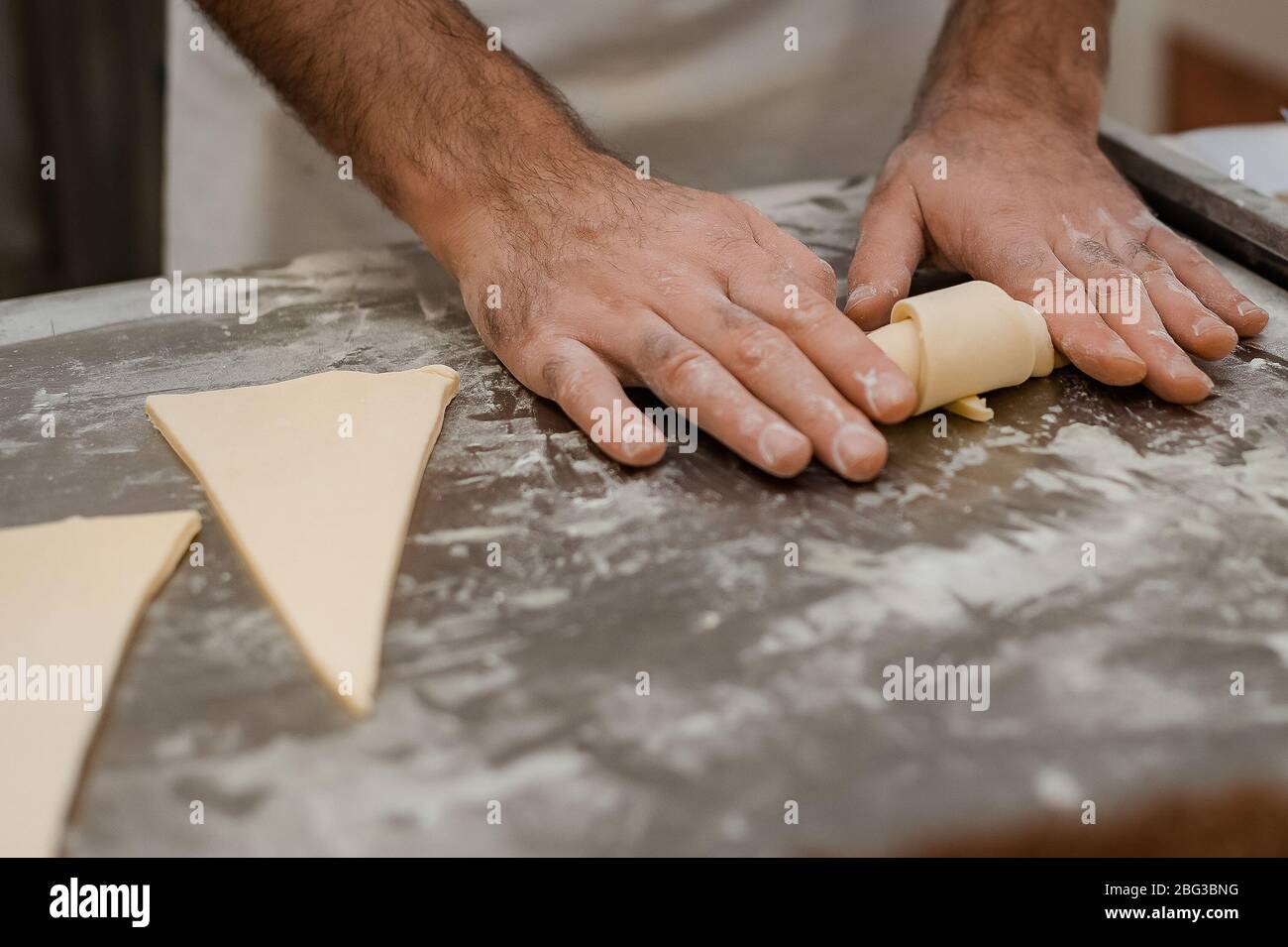 The process of making croissants in a bakery. Selective focus Stock ...