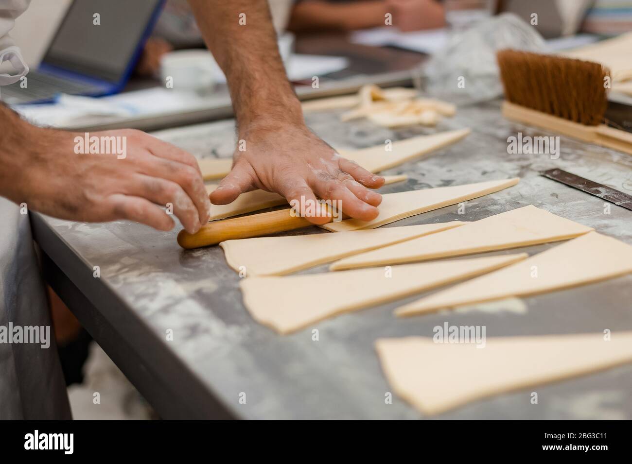 The process of making croissants in a bakery. Selective focus Stock ...