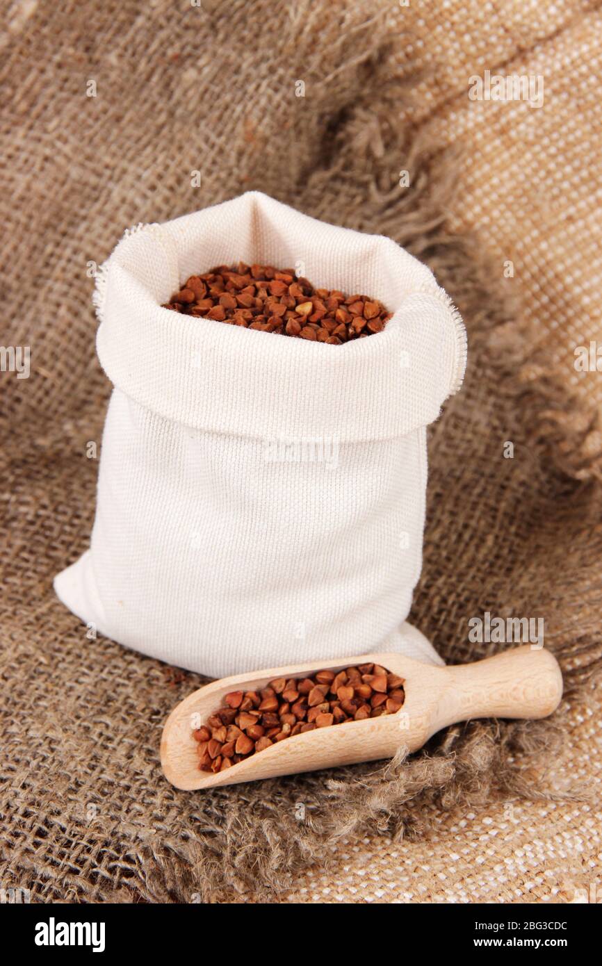 Grains in sack on wooden background Stock Photo - Alamy