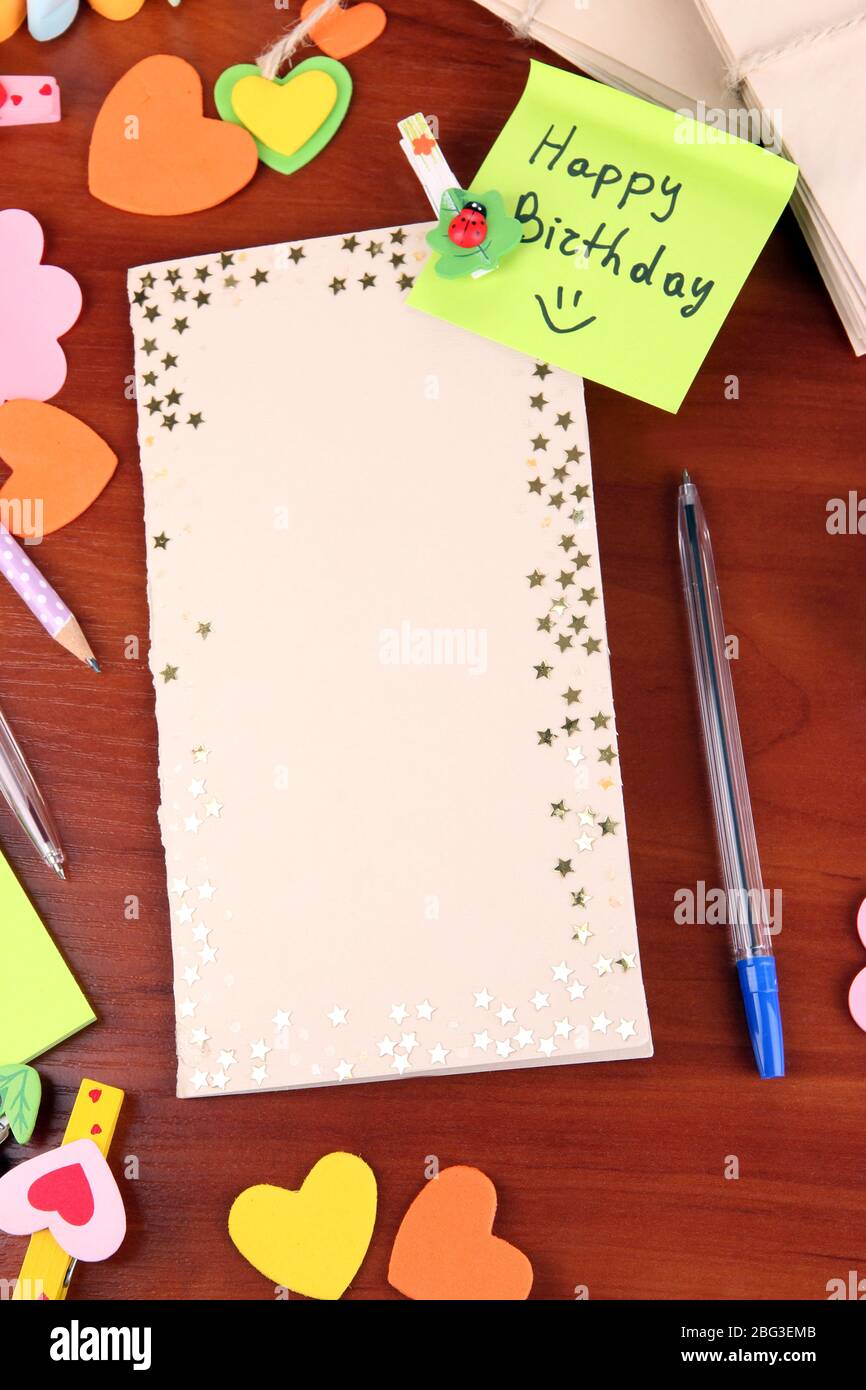 Writing letter of congratulations to Happy Birthday on wooden table ...