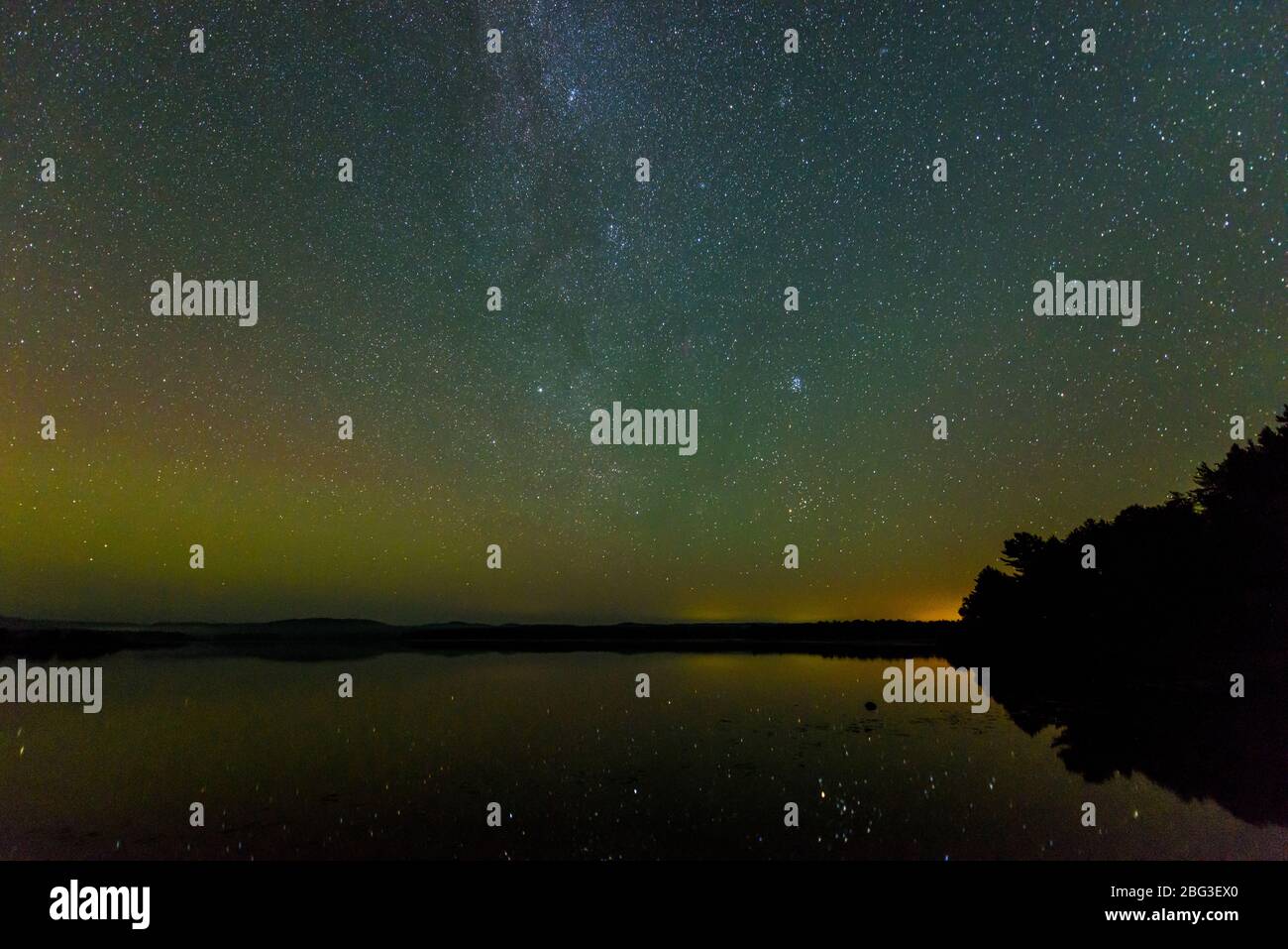 Night sky with Milky Way and faint aurora borealis over Lake Travers ...