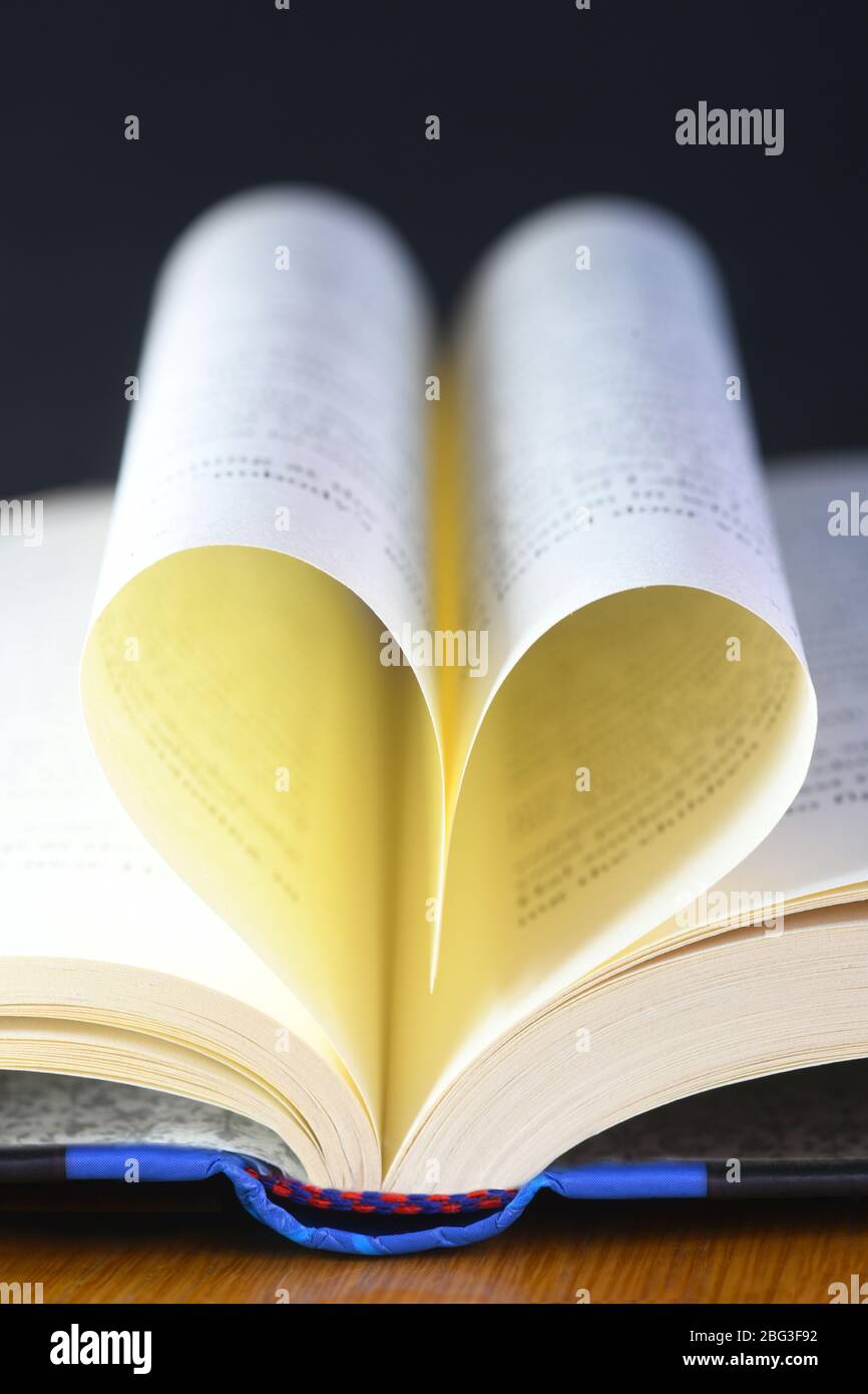 vertical heart shaped book pages showing spine ,selective focus on a ...