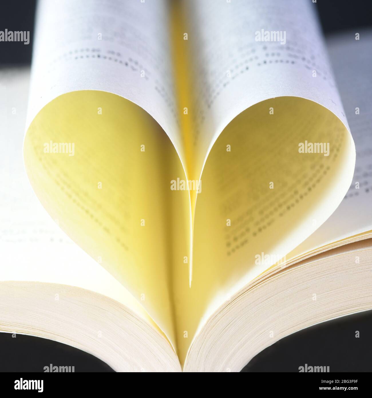 square heart shaped book pages ,selective focus on a black background ...