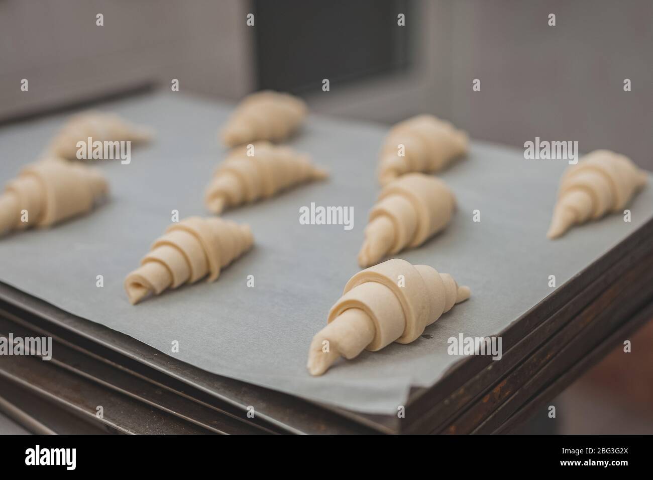 The process of making croissants in a bakery. Selective focus Stock ...