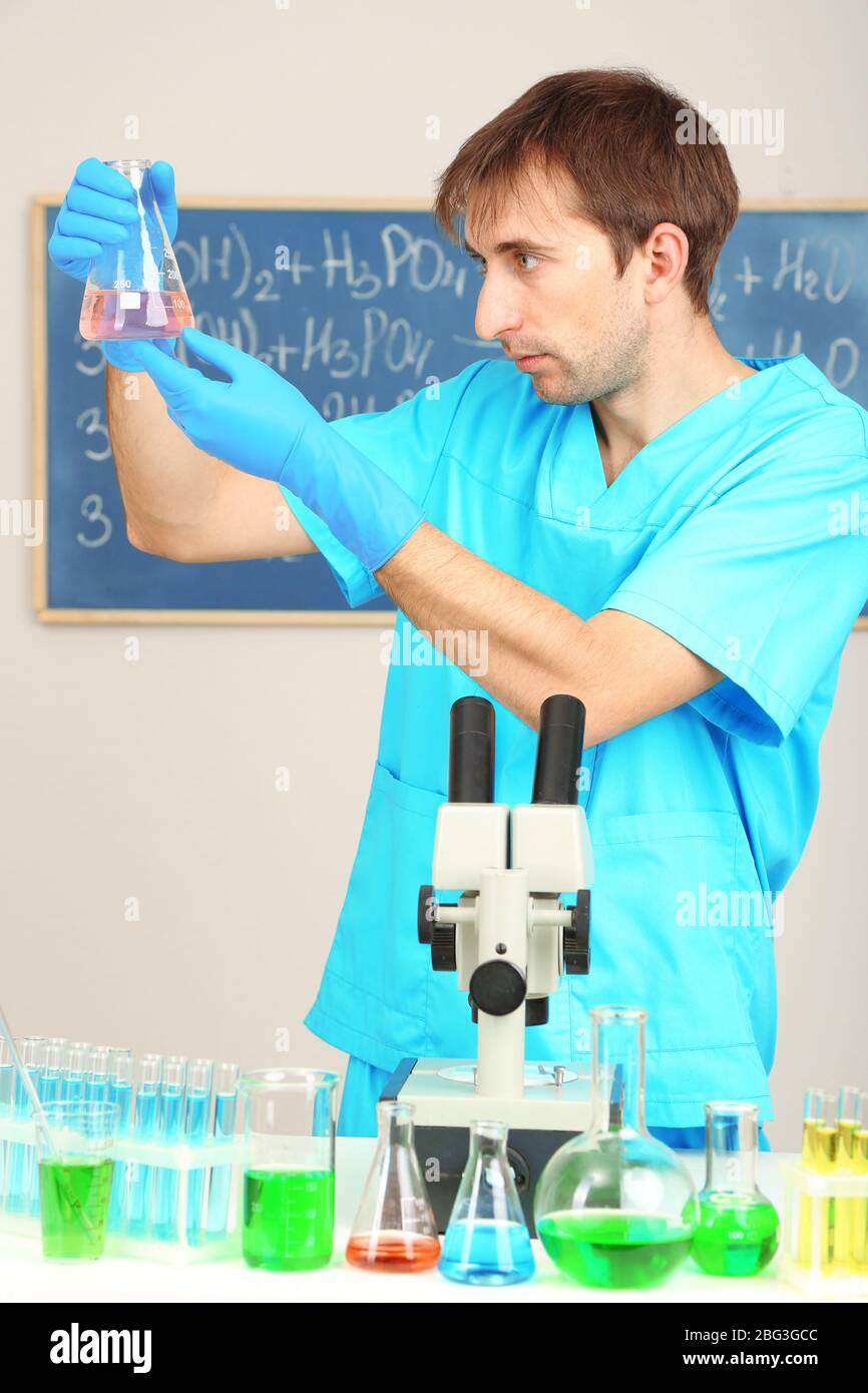 Assayer during research on room background Stock Photo - Alamy