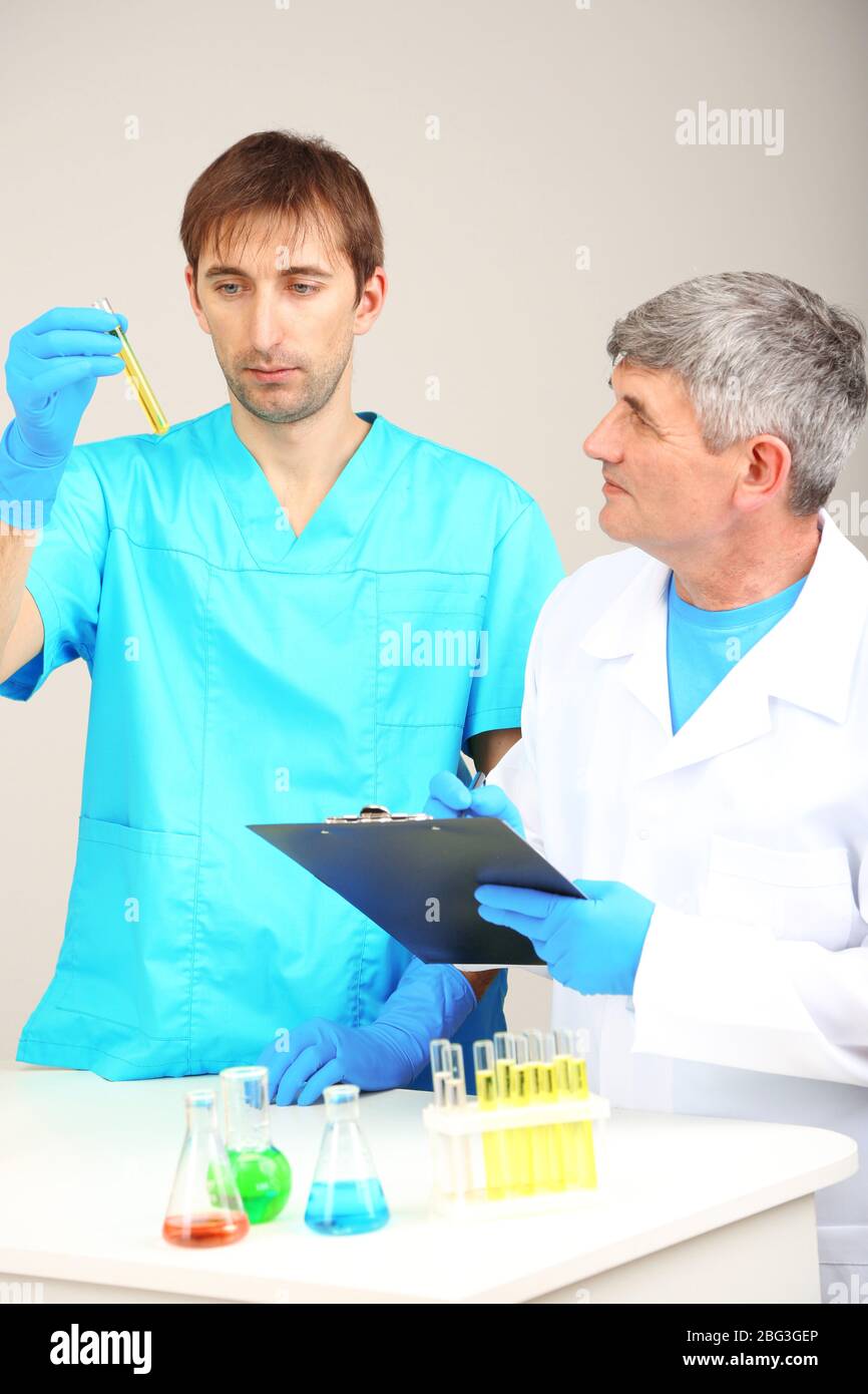 Physician and assayer during research on room background Stock Photo ...