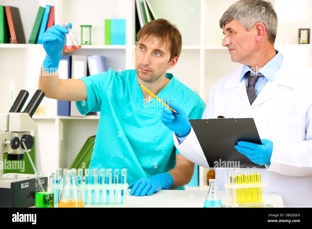 Physician and assayer during research on room background Stock Photo ...