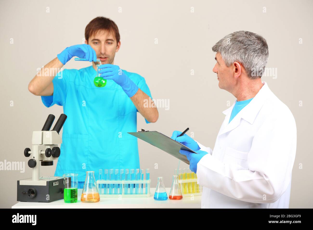 Physician and assayer during research on room background Stock Photo ...