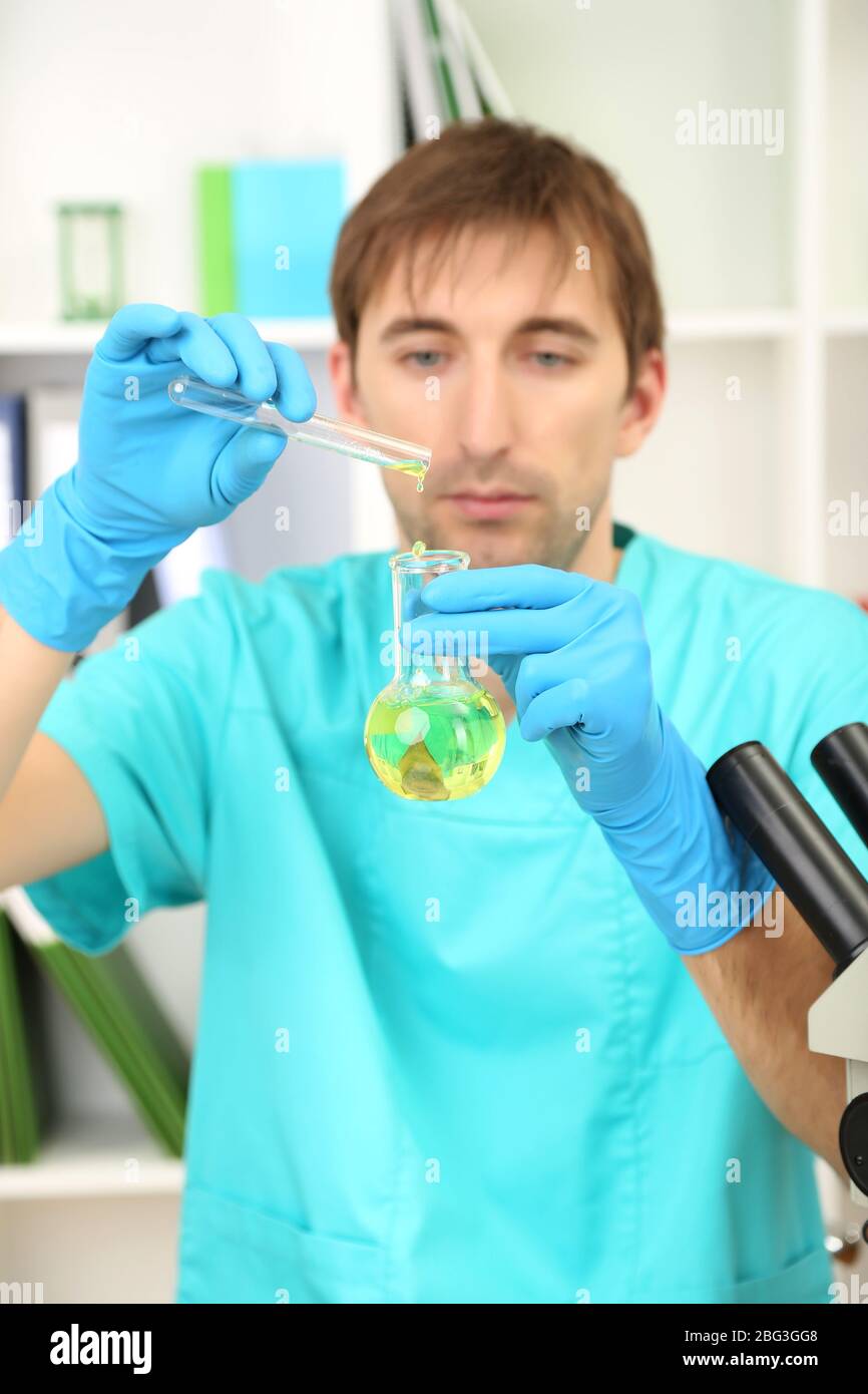 Assayer during research on room background Stock Photo - Alamy