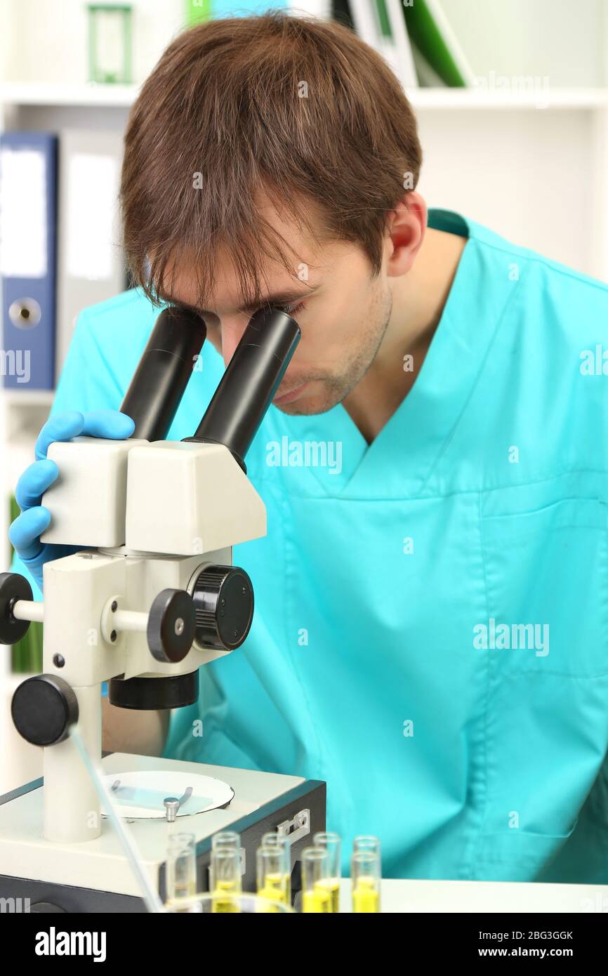 Assayer during research on room background Stock Photo - Alamy