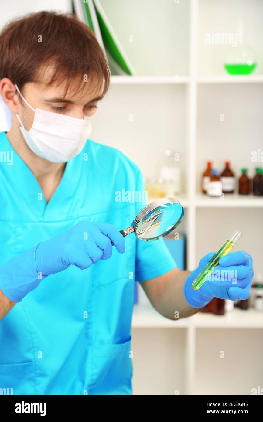 Assayer during research on laboratory background Stock Photo - Alamy