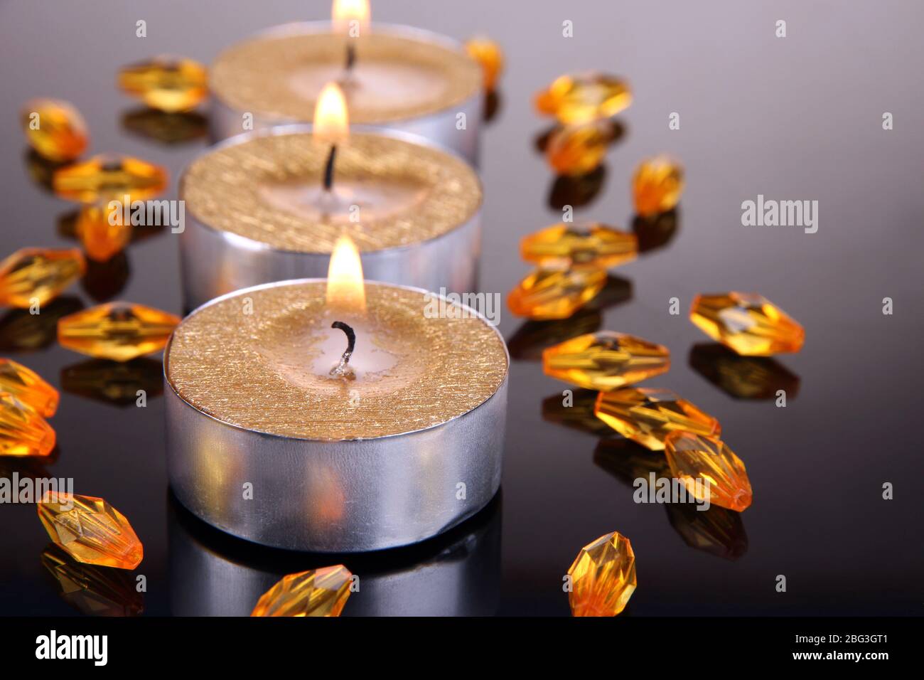 Golden candles isolated on black Stock Photo - Alamy