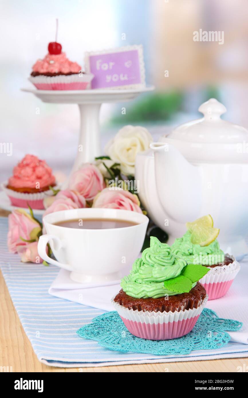 Beautiful cupcakes on dining table on room background Stock Photo - Alamy