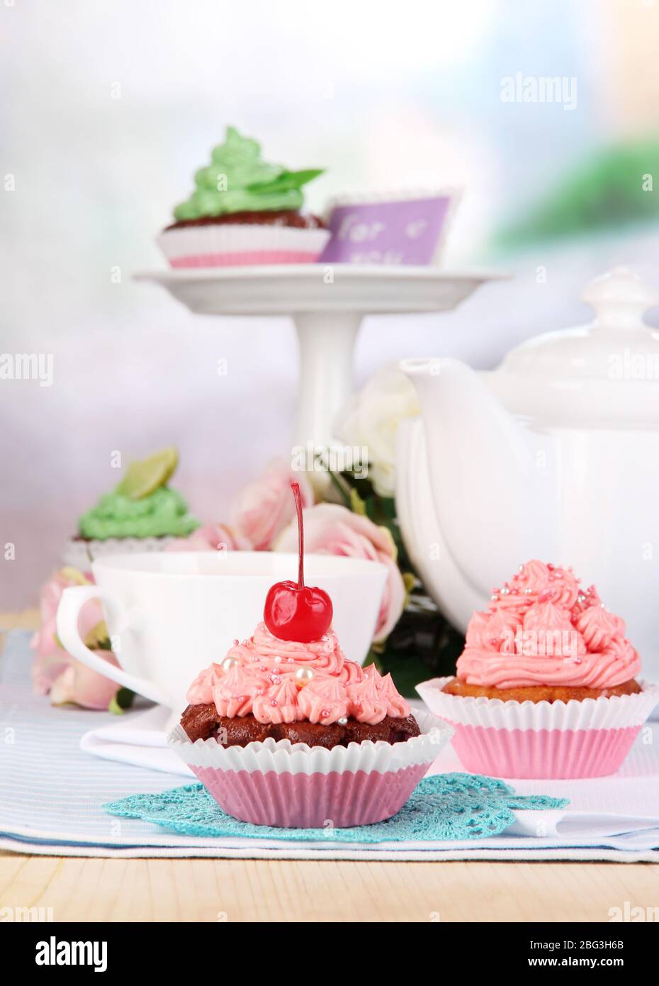 Beautiful cupcakes on dining table on room background Stock Photo - Alamy