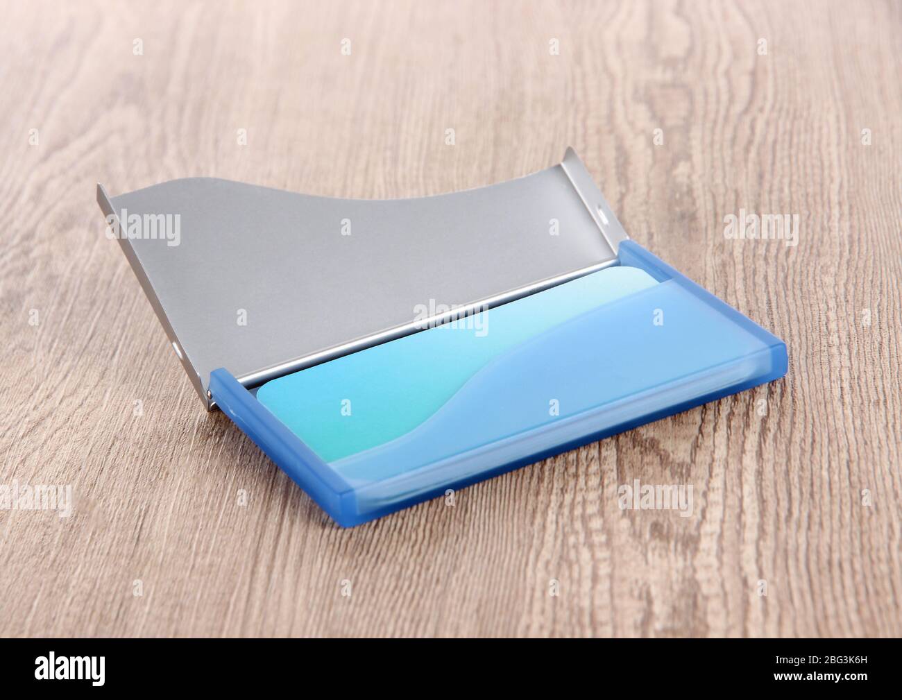 Blue business card holder on wooden background Stock Photo - Alamy