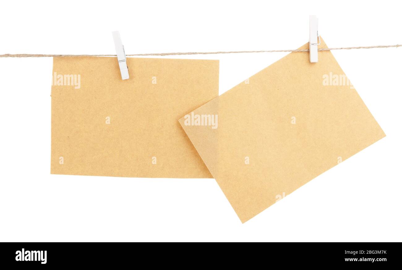 Old sheets of paper hanging on rope isolated on white Stock Photo - Alamy