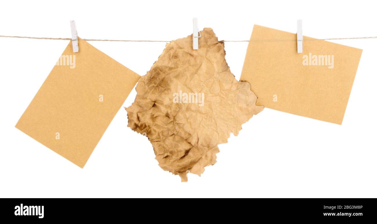 Old sheets of paper hanging on rope isolated on white Stock Photo - Alamy