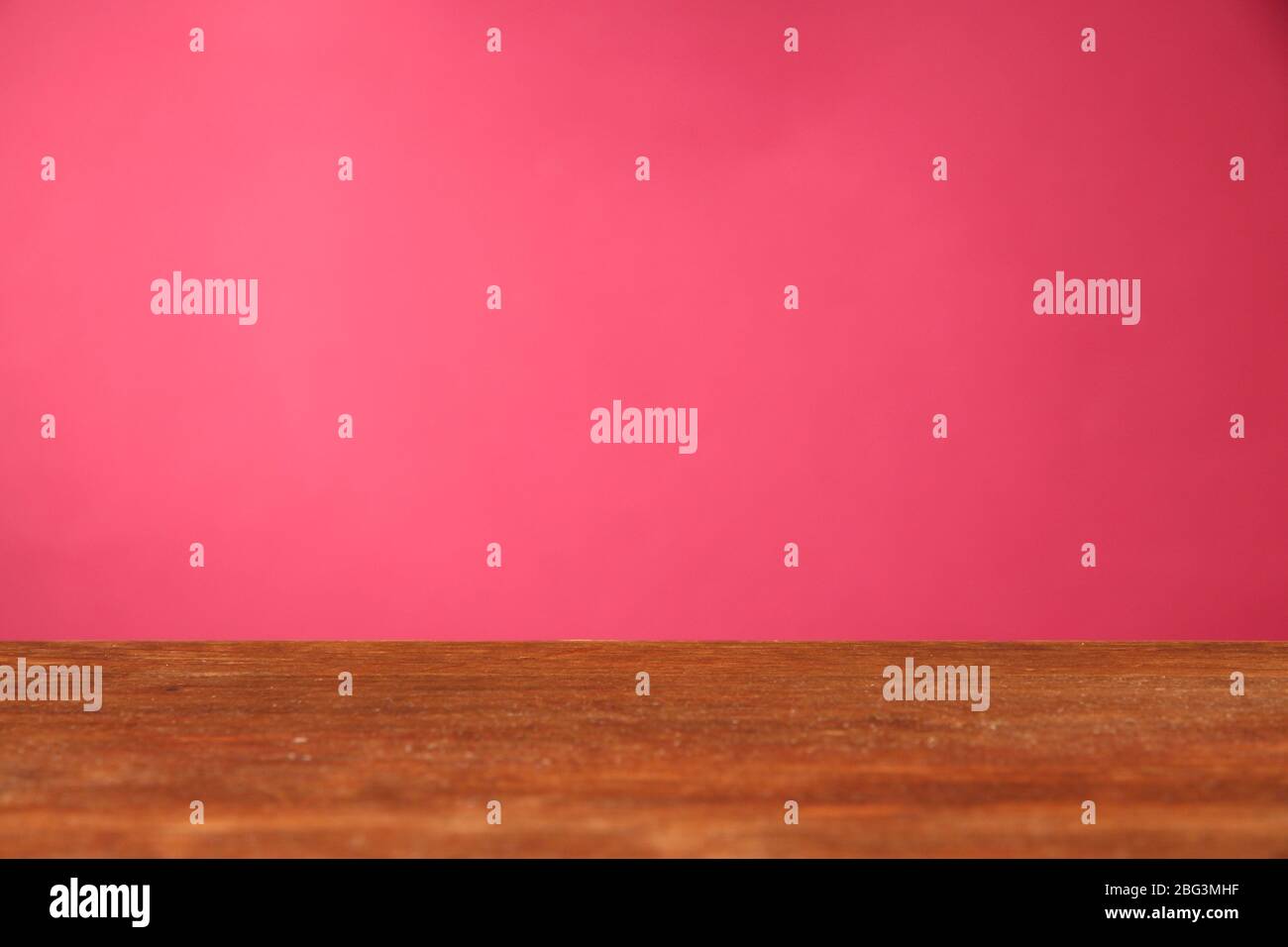 Wooden table on pink background Stock Photo - Alamy