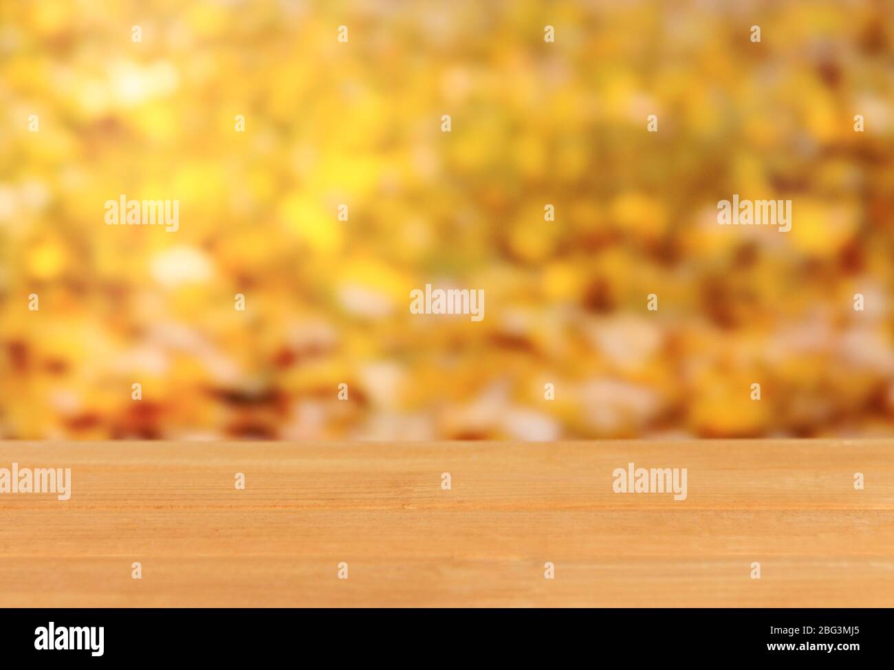 Wooden table on bright yellow background Stock Photo - Alamy