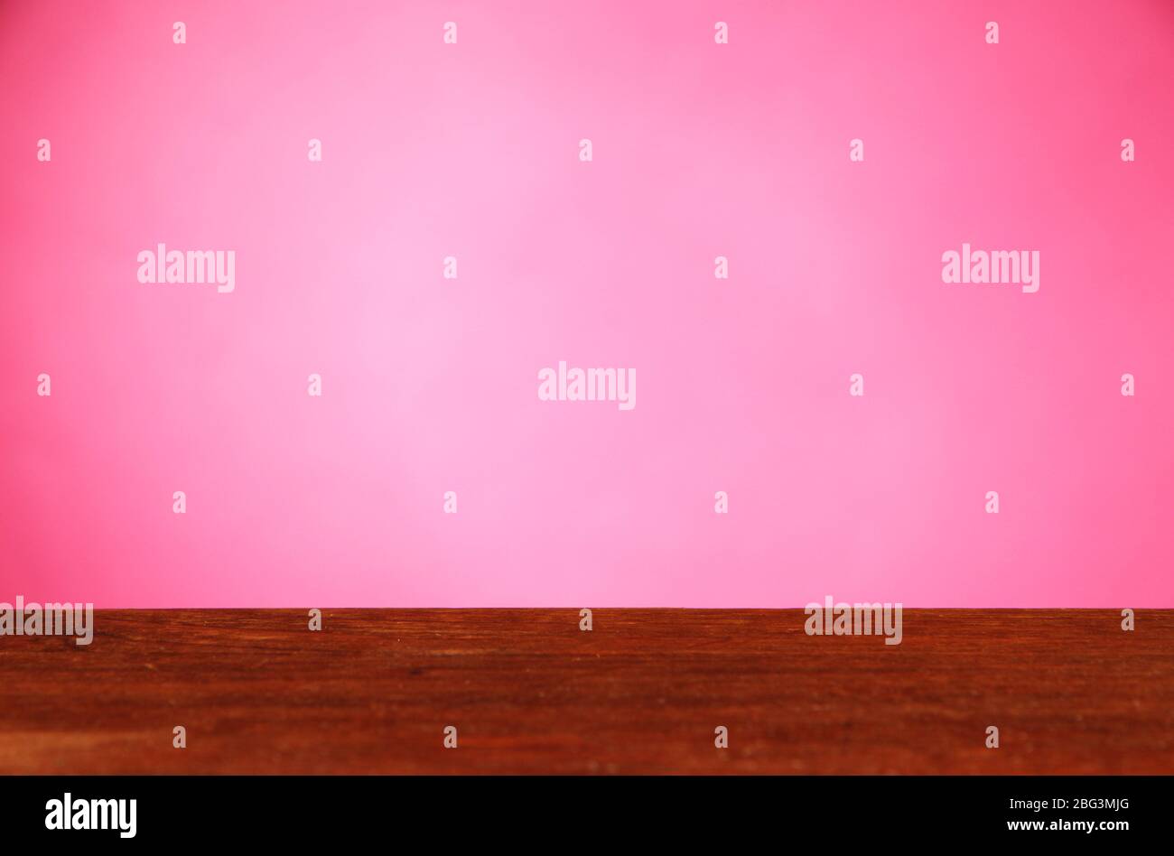 Wooden table on pink background Stock Photo - Alamy