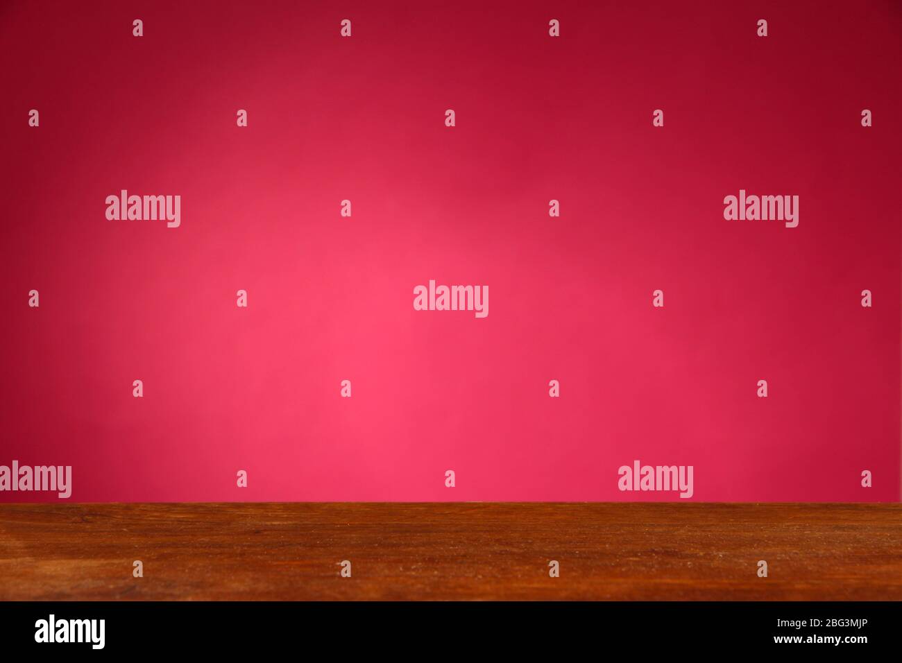 Wooden table on pink background Stock Photo - Alamy