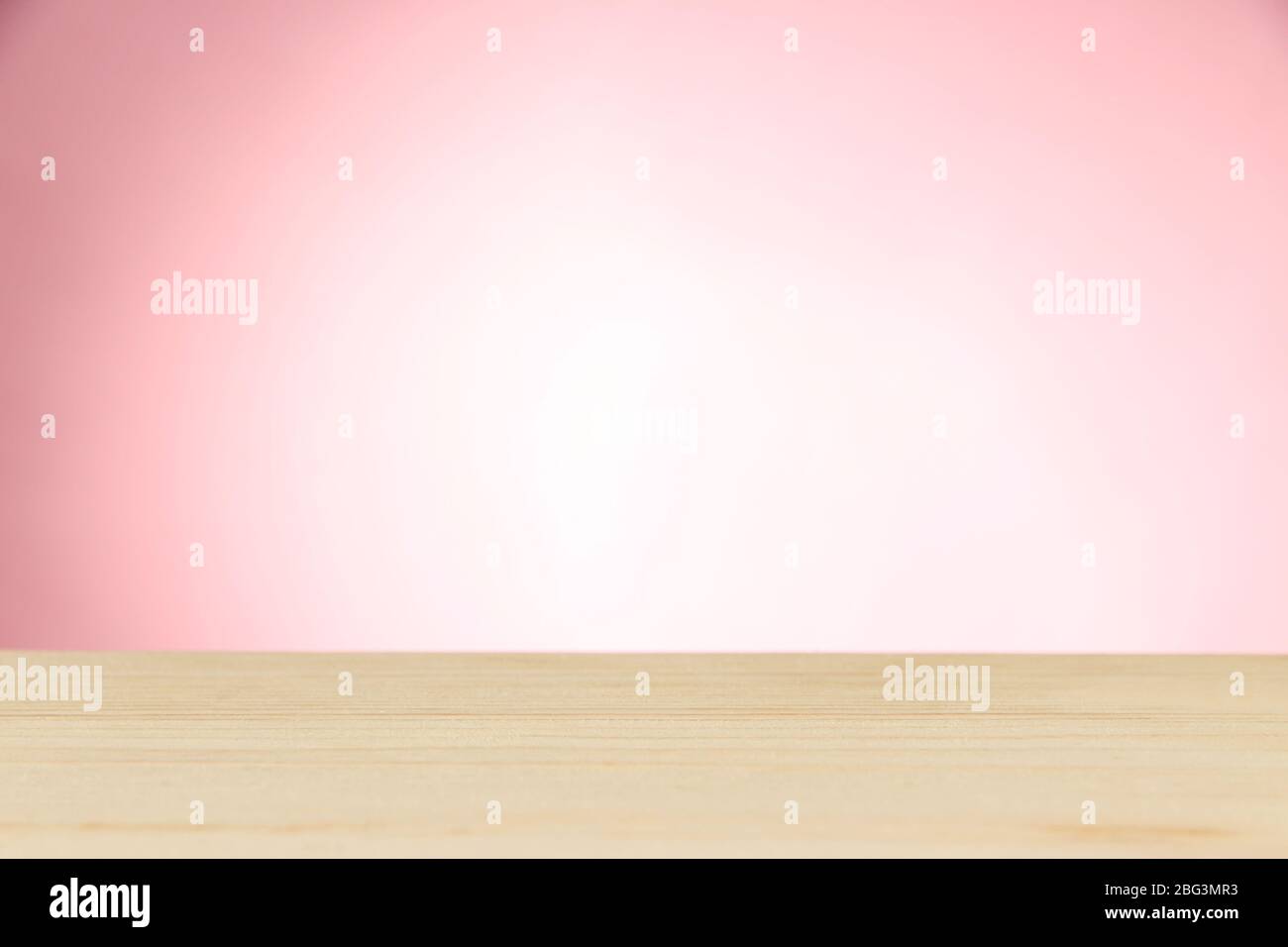 Wooden table on light pink background Stock Photo - Alamy