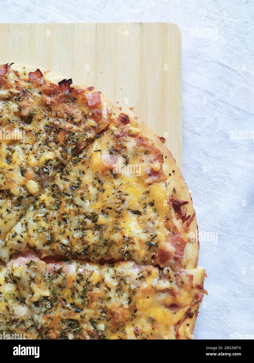 Pizza slices on a wooden chopping board Stock Photo - Alamy